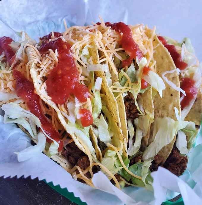 Hard shell tacos piled high enough to require architectural planning and possibly a building permit.