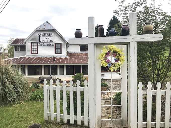 Hickory Flat Pottery's white picket fence frames a creative sanctuary where artisans transform clay into functional beauty.