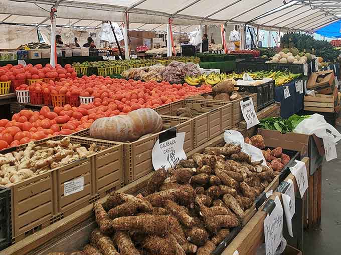 Fresh produce piled high in wooden crates makes grocery stores look sad and overpriced by comparison.