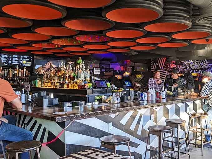 The bar's geometric design pops against those orange ceiling circles, making every drink order feel like an event.