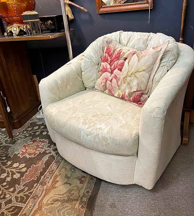 This armchair with floral pillow whispers "sit down and stay awhile," preferably with a good book and zero notifications.