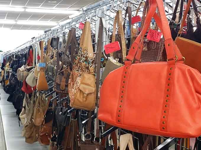 Handbags in every color and style hang like fashion possibilities, proving accessories don't require mortgage payments.