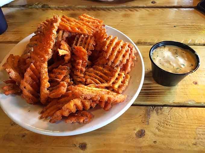 Sweet potato fries arranged like edible architecture &ndash; crispy, golden, and begging to be devoured immediately.
