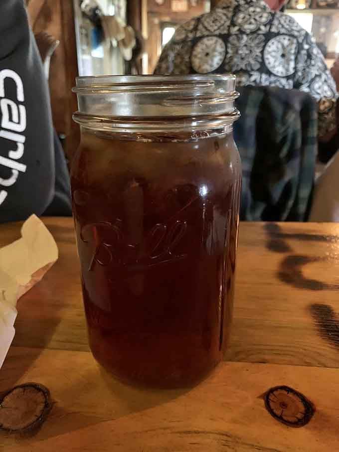 Sweet tea served in a mason jar, because fancy glassware has no place in authentic ranch country dining experiences.