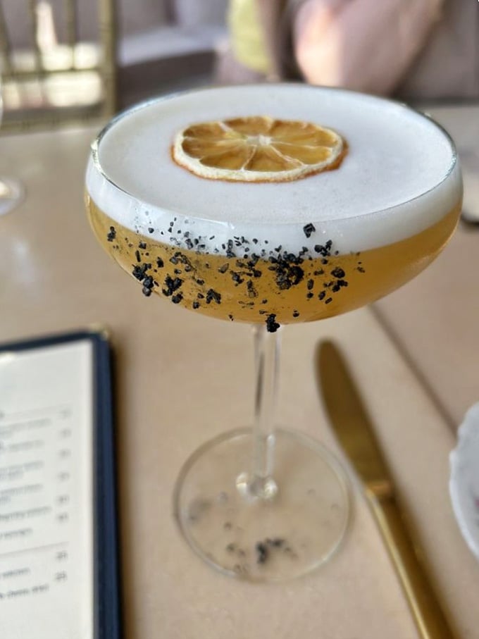 That citrus wheel and foam top make this cocktail look like it's dressed for a party you definitely want.