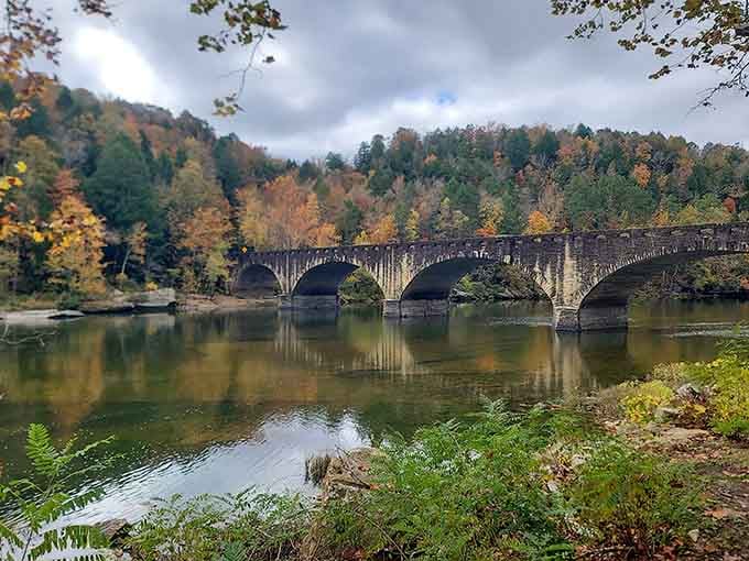 The historic bridge spans the river like a postcard from another era, perfectly framed by Kentucky's finest fall colors.