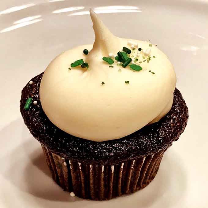 That smooth frosting swirl and festive garnish make this cupcake look almost too pretty to eat.