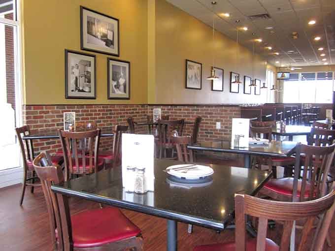 Exposed brick, framed vintage photos, and polished tables create an atmosphere that's both nostalgic and contemporary.