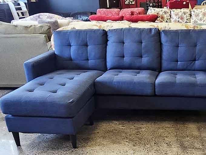 That blue sectional sofa looks better than half the new furniture at regular stores, honestly.