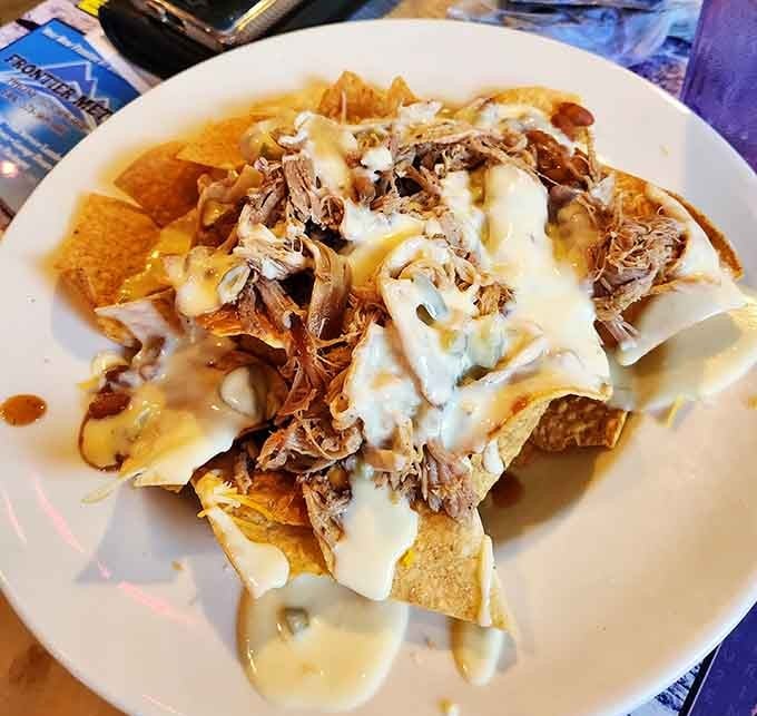 Pulled pork nachos covered in cheese and drizzled with sauce prove that fusion food doesn't have to be fancy.