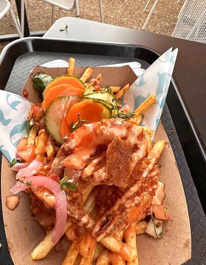 Shrimp frites loaded with pickled vegetables prove that sometimes more is definitely more when it comes to toppings.