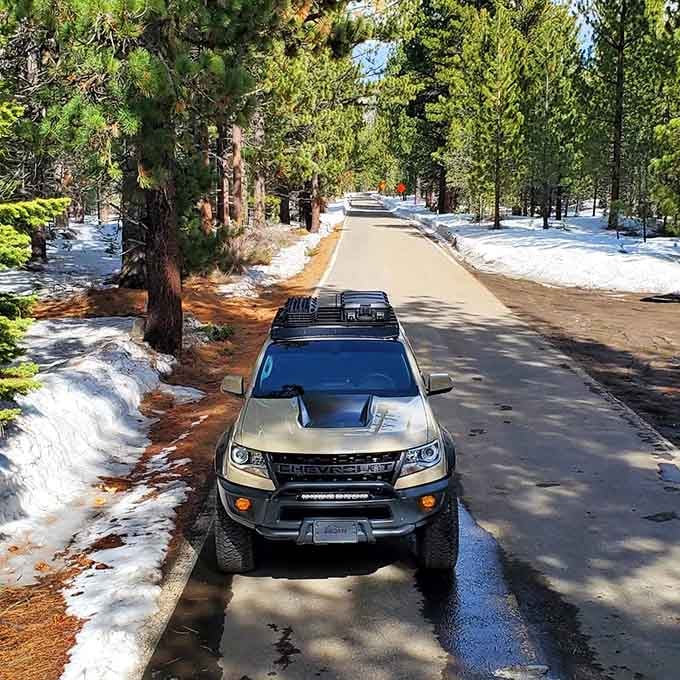 Winter transforms the byway into a snow-dusted wonderland, though your sedan might prefer to admire from lower elevations.