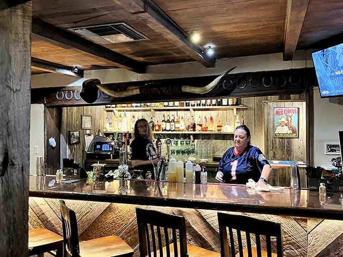 The bar area combines rustic charm with modern comfort, perfect for enjoying a pre-dinner cocktail or three.