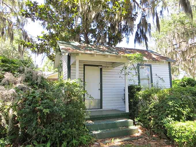 White clapboard siding and a sagging porch tell the story of a home that once sheltered families along the Suwannee.