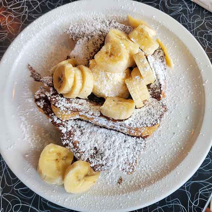 French toast dusted with powdered sugar and crowned with bananas, because breakfast should feel indulgent.