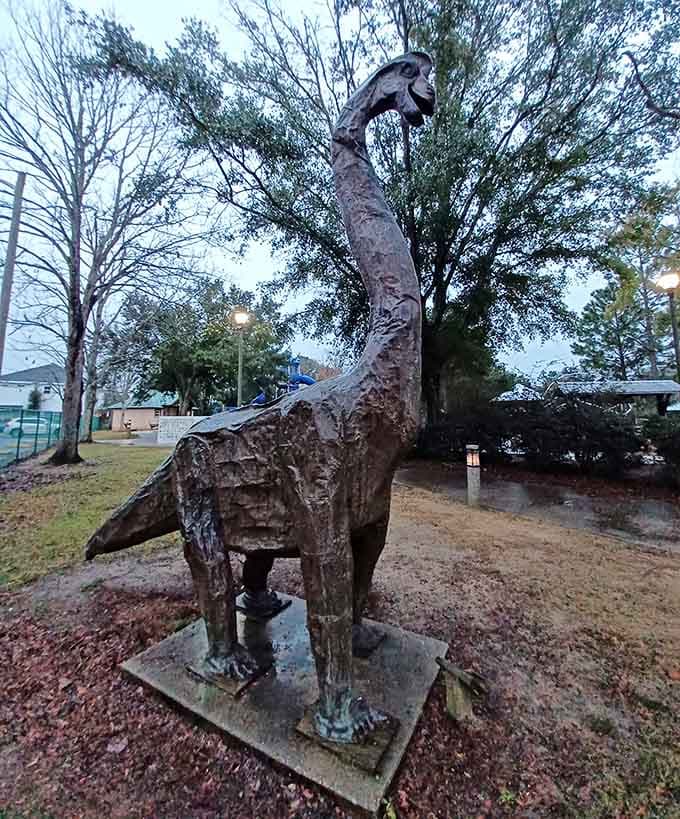 This impressive dinosaur statue stands guard over the playground like a friendly prehistoric sentinel welcoming young visitors.