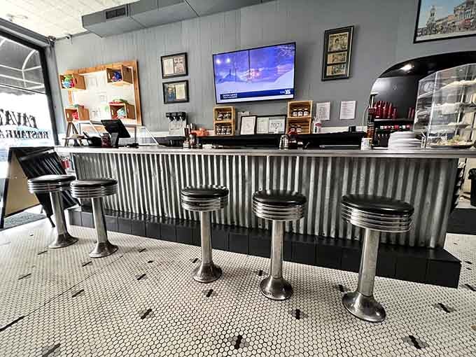 The classic diner counter where coffee flows freely and conversations happen naturally between bites.