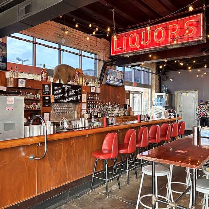 Vintage signs and exposed ductwork create an atmosphere that's equal parts nostalgia and modern Louisville cool vibes.