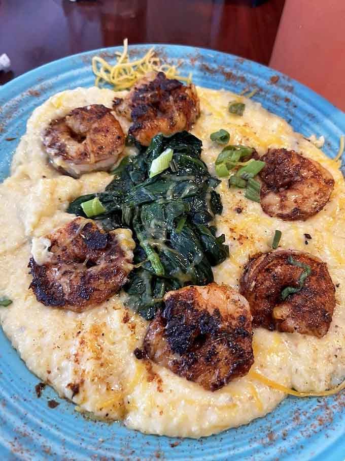Blackened shrimp nestled in cheesy grits like they've found their forever home, and honestly, same.