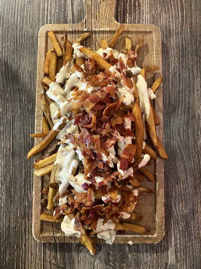 Queso Flamme Fries: because regular fries are fine, but fries drowning in homemade queso are a religious experience.