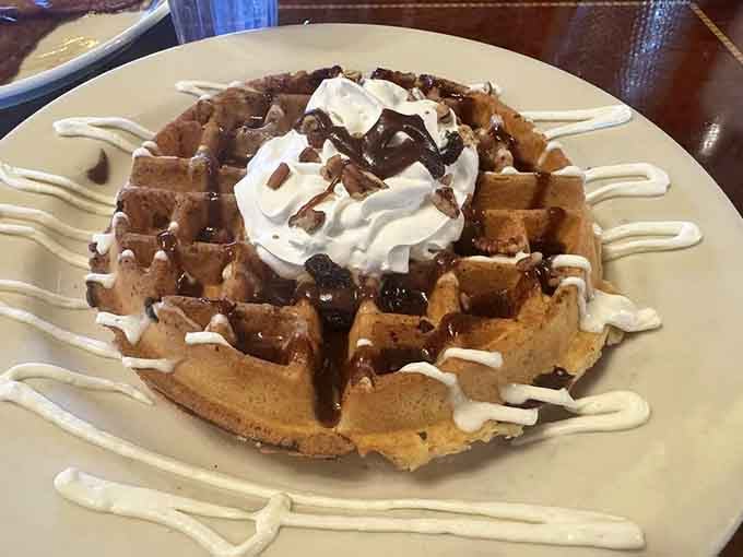 Waffles topped with whipped cream and chocolate drizzle, because moderation clearly took the day off at Frank's.