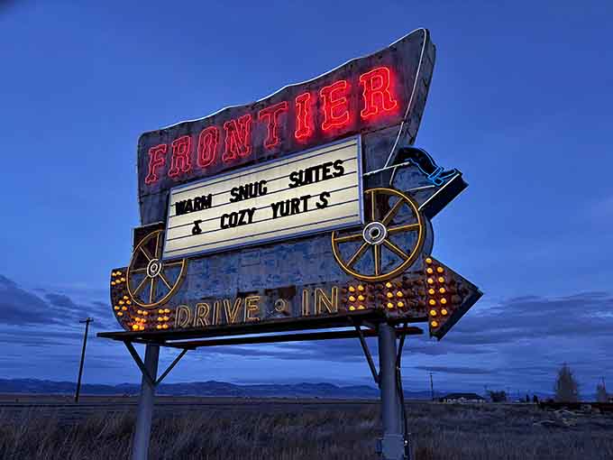 The vintage Frontier sign glowing against twilight sky hits different when you know what's waiting beyond it.