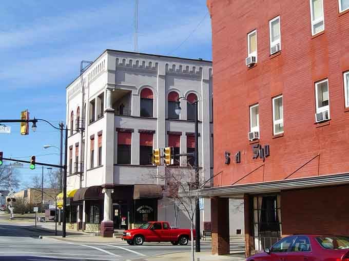 Historic architecture meets modern commerce where three-story buildings showcase the town's evolution from textile hub to charming destination.