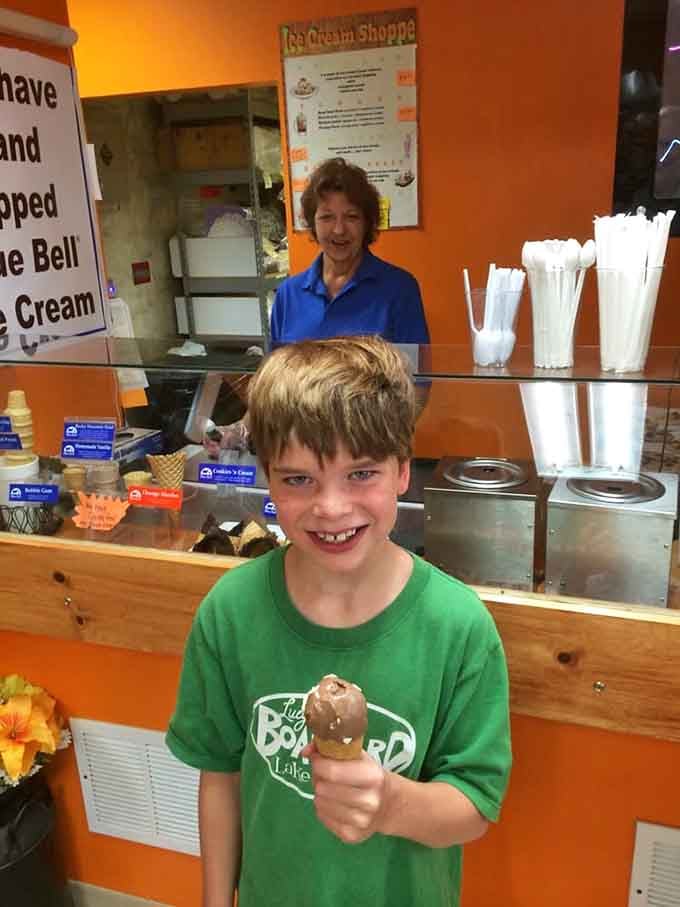 Pure joy captured in one smile and one scoop of ice cream on a perfect mountain day.