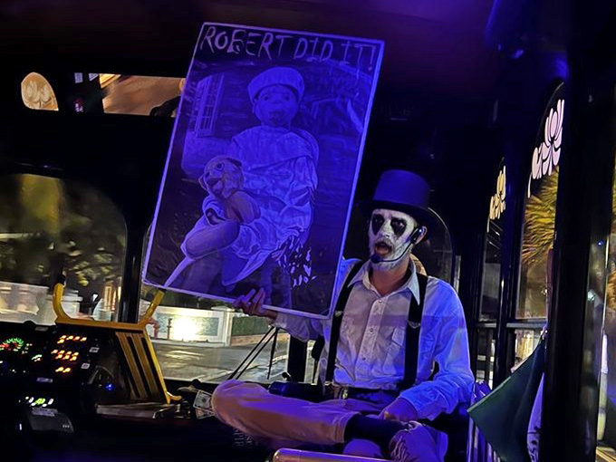 The "Robert Did It" sign suggests this doll has quite the reputation for mischief and unexplained occurrences around town.