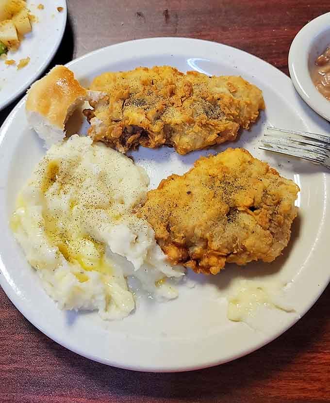 Chicken fried steak drowning in white gravy alongside tater tots and toast is pure comfort food poetry in motion.