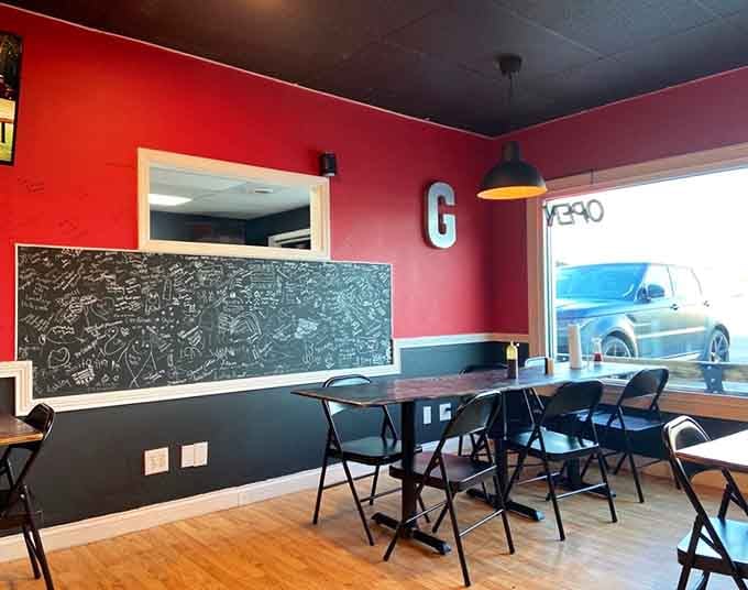 The chalkboard wall invites diners to leave their mark, creating a community canvas of barbecue appreciation.