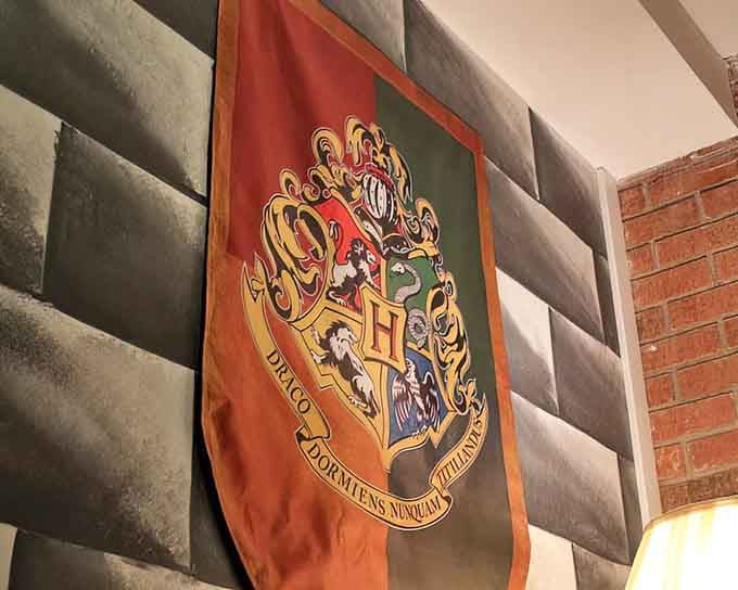 The Hogwarts crest hangs proudly, reminding guests that all four houses are welcome under this enchanted roof.