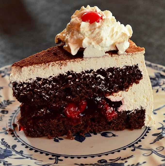 Black Forest cake towering with whipped cream and cherries is how Germans say "you deserve this."