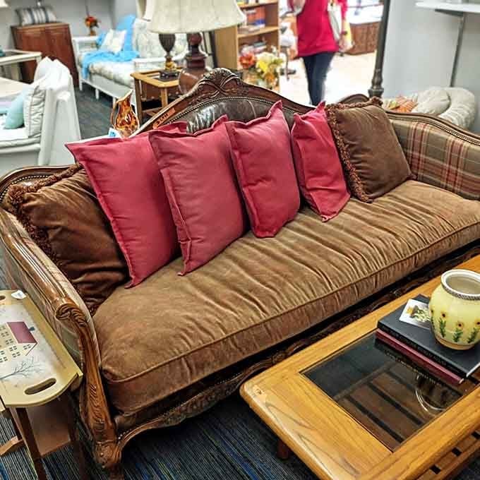 That vintage sofa with burgundy pillows is basically begging you to take it home today.