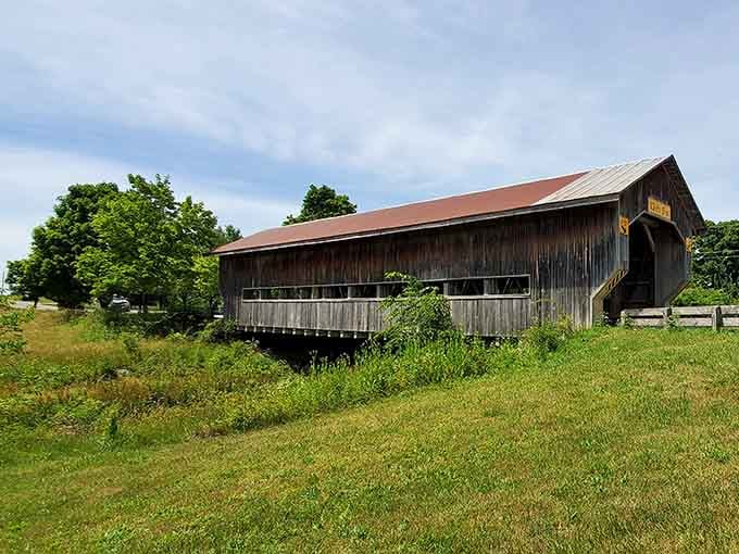 Summer greenery surrounds the bridge like a lush embrace, proving every season brings its own magic here.
