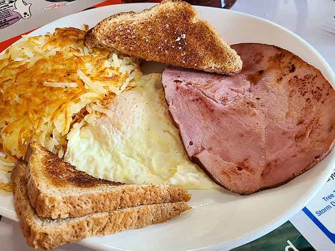 Ham steak and eggs with toast represent breakfast done right, no frills needed when quality speaks volumes.