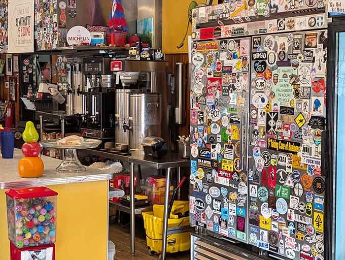 The sticker-covered wall near the coffee station shows the kind of personality that can't be manufactured or faked.