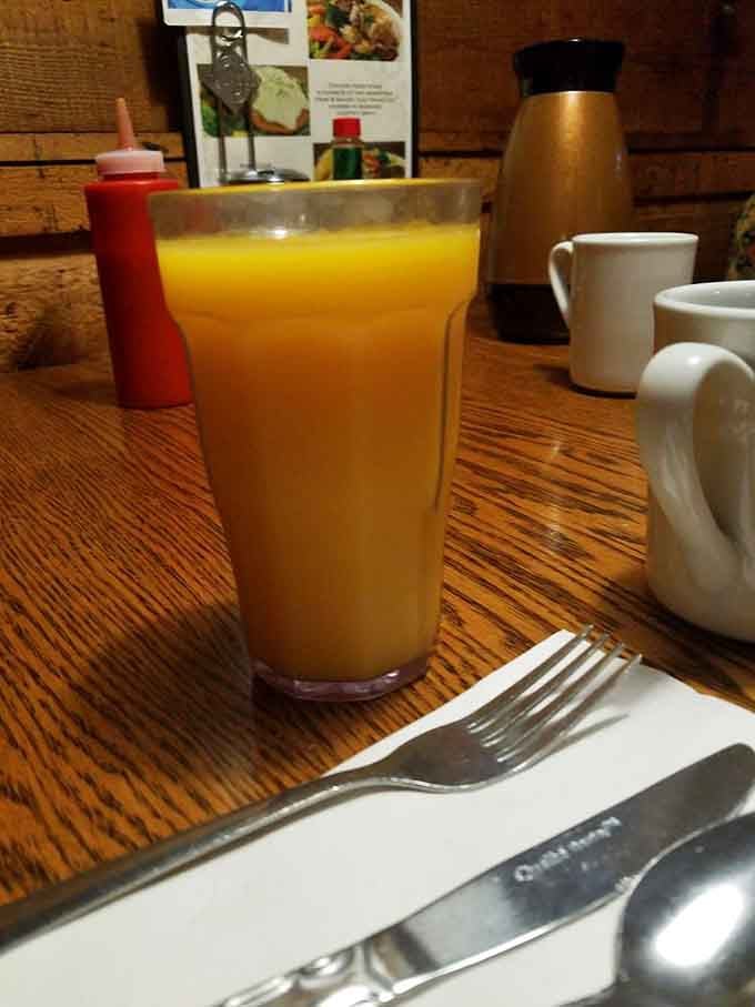Orange juice served in a glass big enough to make you feel virtuous about your breakfast choices.