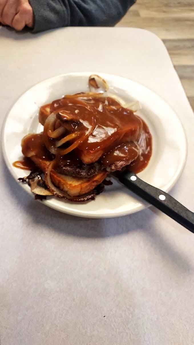 Steak smothered in gravy and onions demonstrates that sometimes the simplest preparations deliver the most satisfying results.