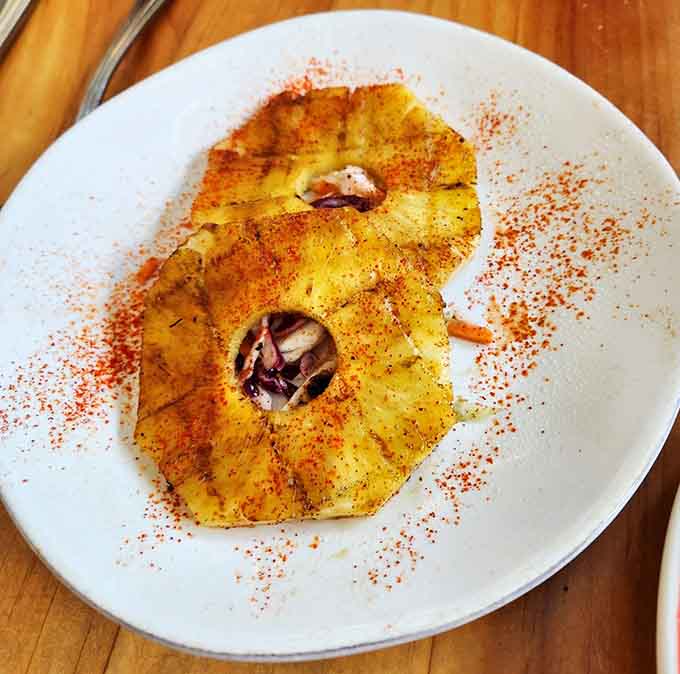 Grilled pineapple rings dusted with spice, turning simple fruit into something unexpectedly spectacular and sweet.