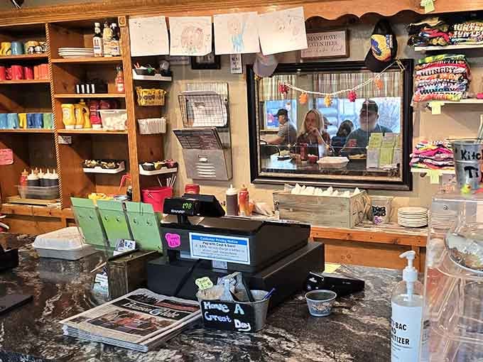 The counter area shows off local charm with shelves full of character and a glimpse into the kitchen action.
