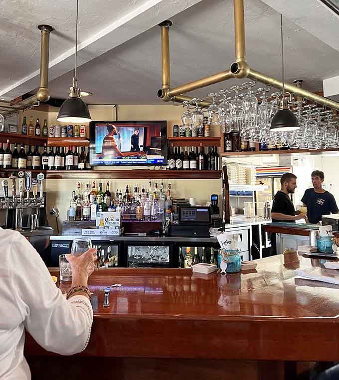 The bar area balances casual comfort with a well-stocked selection for those seeking liquid refreshment.