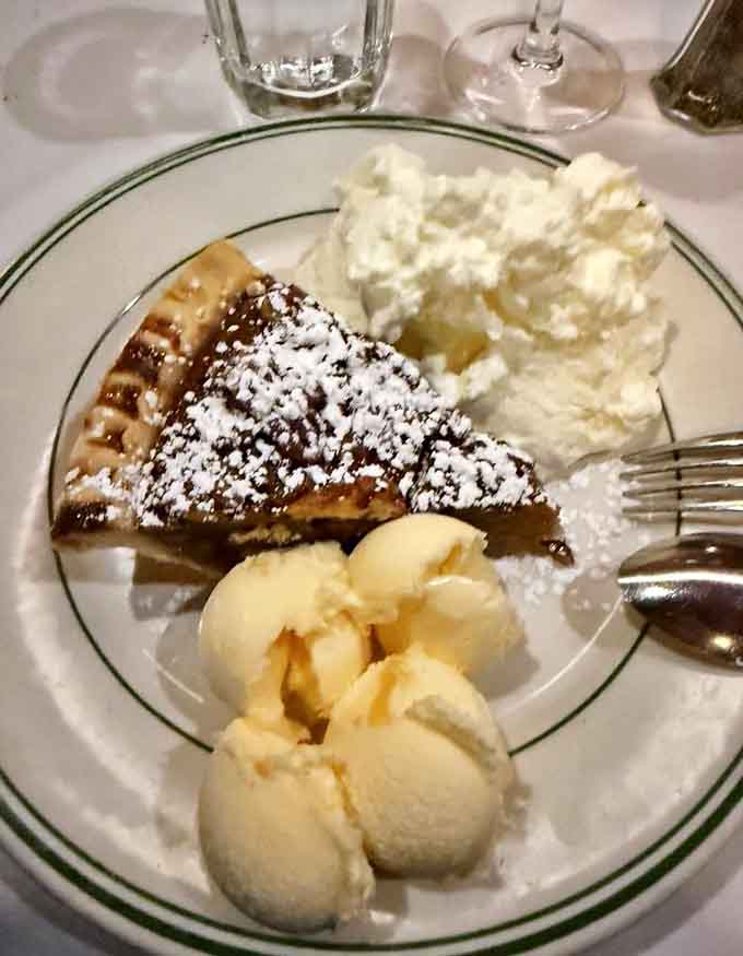 Pecan pie with vanilla ice cream and whipped cream, because after that steak, you've earned every calorie of this sweet finale.