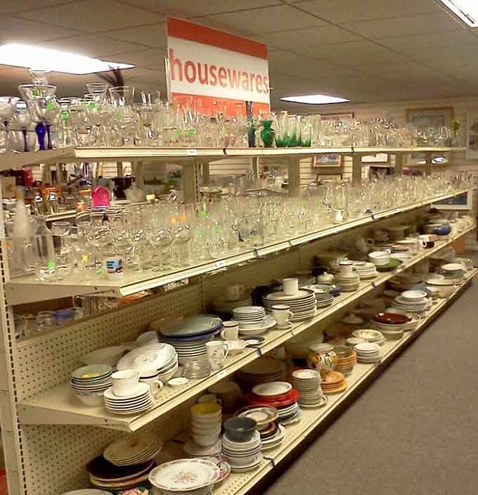 Wine glasses, dishes, and serving pieces organized like an actual store&mdash;revolutionary thrift shop thinking right here, folks.