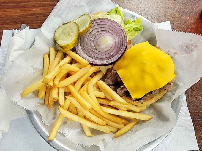 A burger loaded with cheese, onions, and all the fixings proves Kate's Kitchen doesn't quit after breakfast hours end.