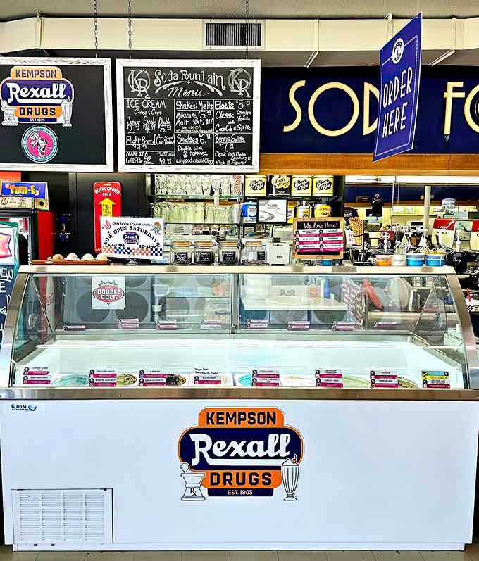 The ice cream case displaying its colorful treasures like edible jewels behind glass, ready for their close-up moment.