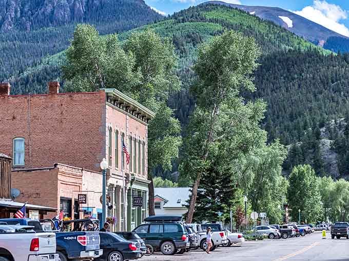 Historic brick buildings stand against mountain backdrops like they're posing for Colorado's official postcard, which they probably are.