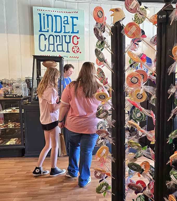 Three generations discovering sugar together, proof that candy stores are the great unifier of all ages.