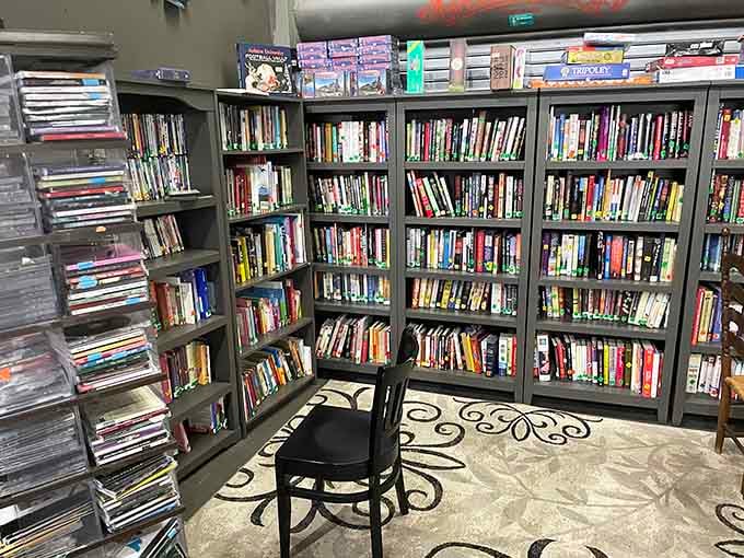 Books and DVDs stacked high enough to fuel binge-reading and binge-watching marathons for months ahead.