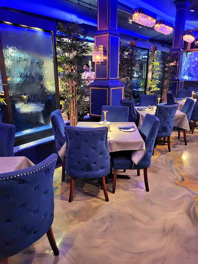 Elegant dining spaces where waterfalls and aquariums create ambiance that makes every meal feel like a special occasion worth celebrating.